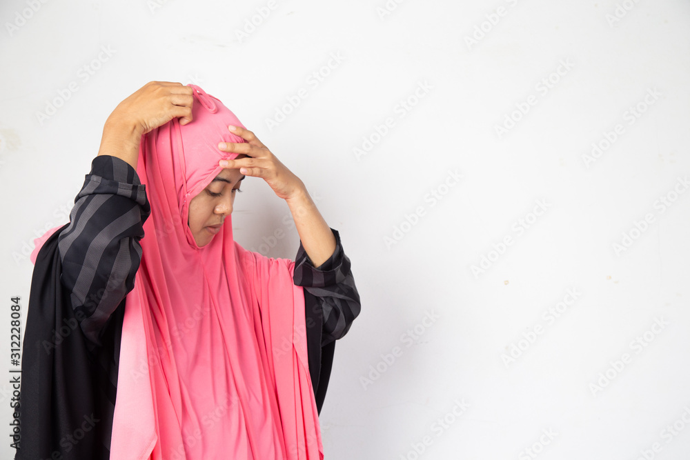 Muslim women standing prepare to wear a hijab in the mosque for prayer ...