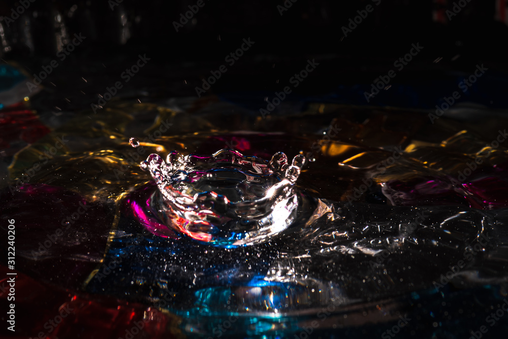 water drops splash forming ripples and waves and abstract water columns ...