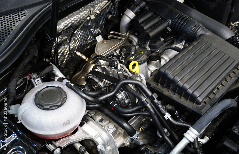 The engine compartment and engine of a modern car. In the center of the ...