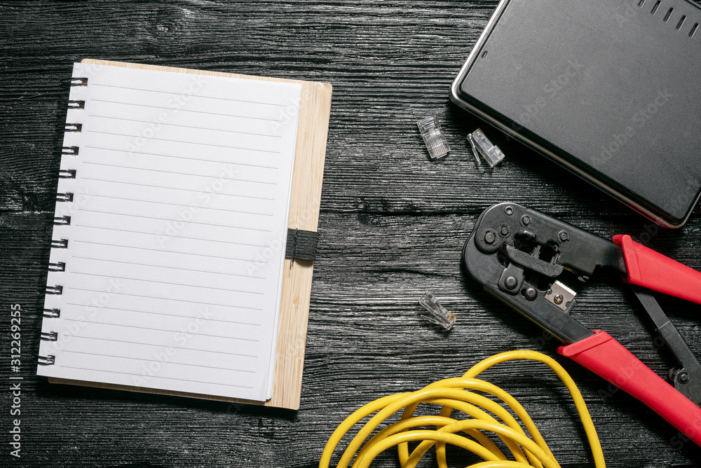 Computer network laying concept. Blank paper page, crimper tool, utp ...