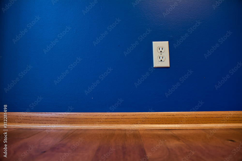 Blue Wall with an Electrical Outlet and a Wooden Floor Stock Photo ...