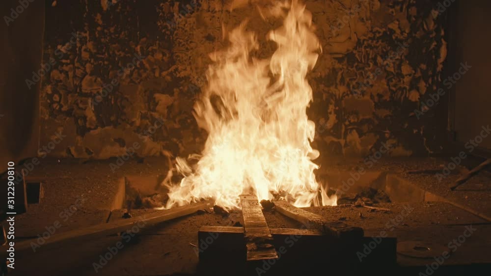 Stockvideon Forge fire in furnace. Blacksmith tempers a steel product ...
