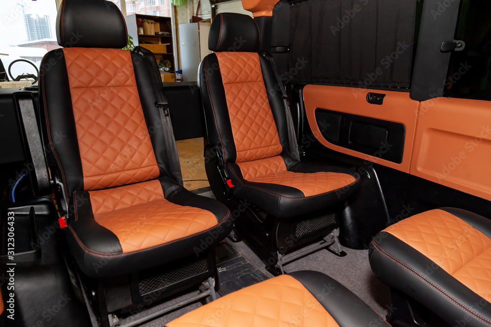Four rear seats in a minibus are deployed to each other and tightened ...