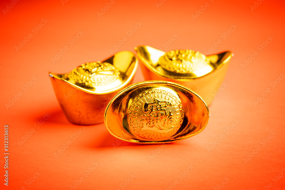 Chinese gold bars against red background. The wordings on bar is ...
