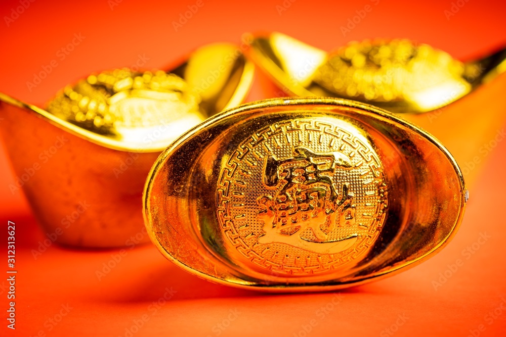 Chinese gold bars against red background. The wordings on bar is ...