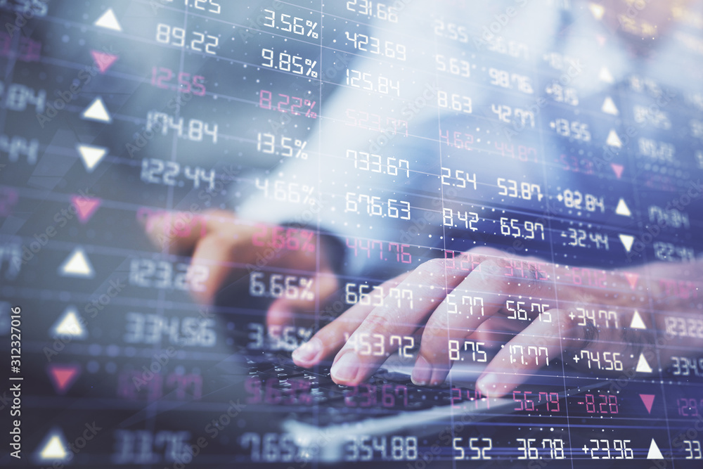 Forex graph with businessman typing on computer in office on background ...