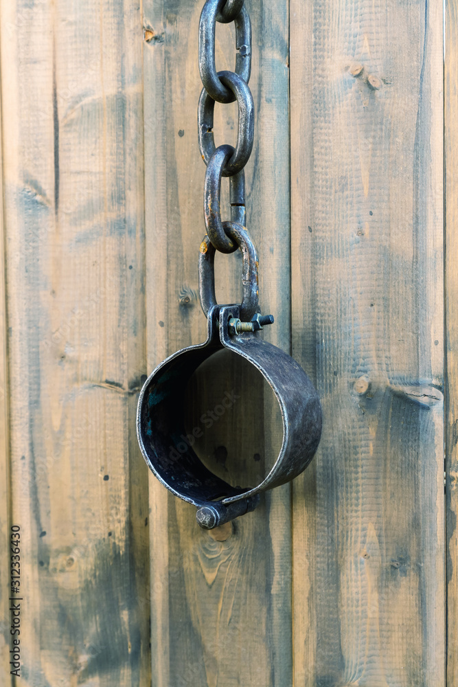 old shackles metal handcuffs on chains arrest slavery wooden vertical ...