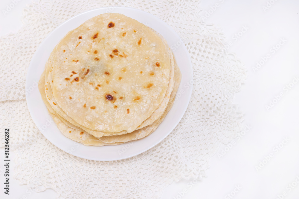 indian chapati bread. chapati on a white plate on a white background ...