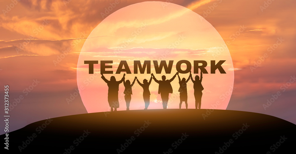 Teamwork business people raised arms holding TEAMWORK letters on the ...