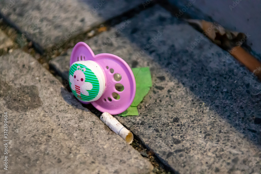 Dusseldorf, Germany - Grotesque Cigarette Butt Lying next to a Children ...