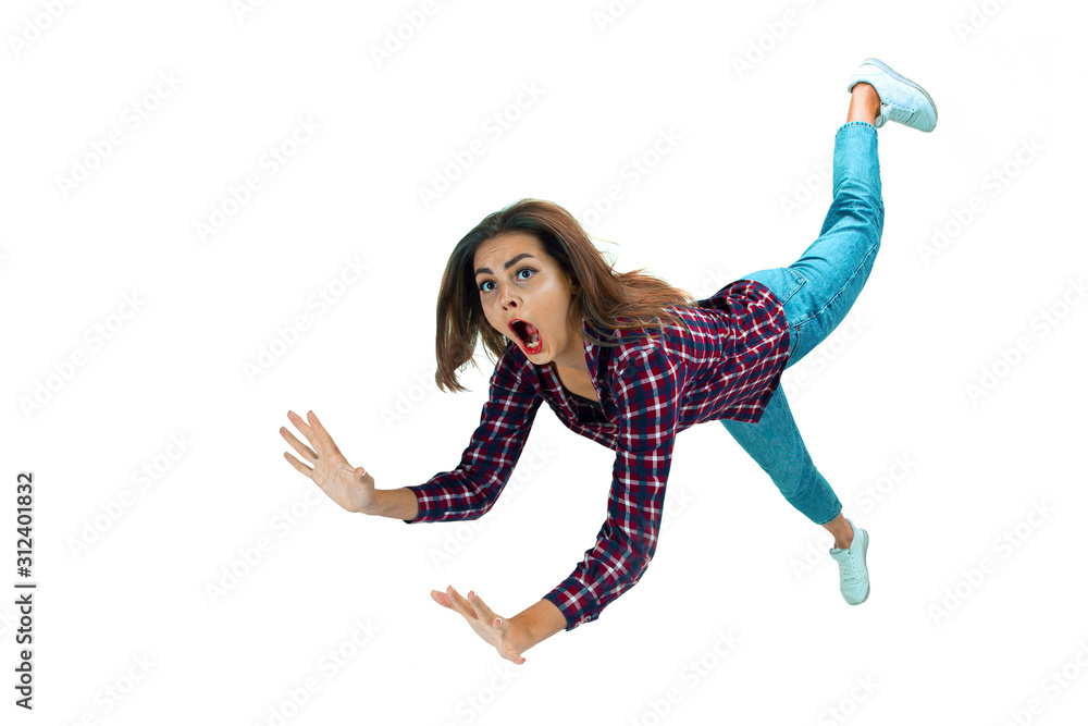 A second before falling. Caucasian young girl falling down in moment ...