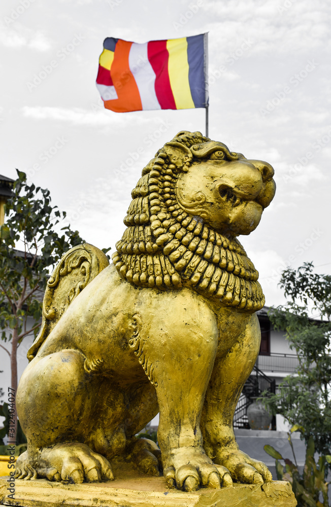 Brave Lion Posture sitting Statue in Gold with Buddhist flags in ...