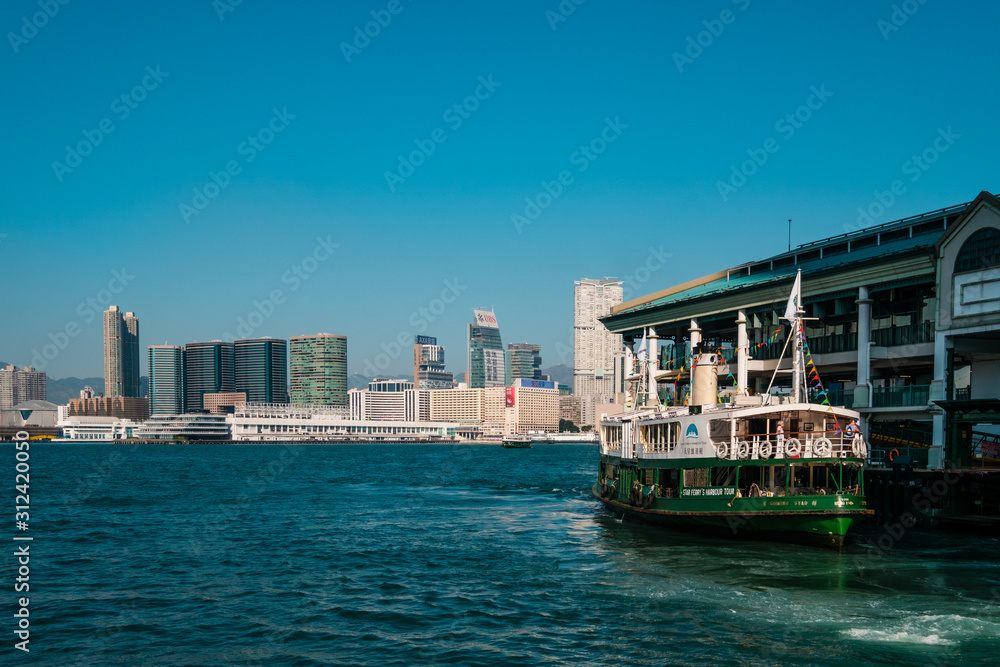 Star Ferry boat on Central Star Ferry Pier and Kowloon skyline ...