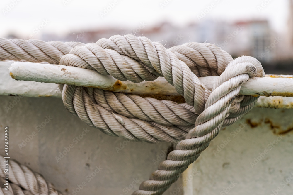 sailor knot made with thick white rope with white rusty background ...