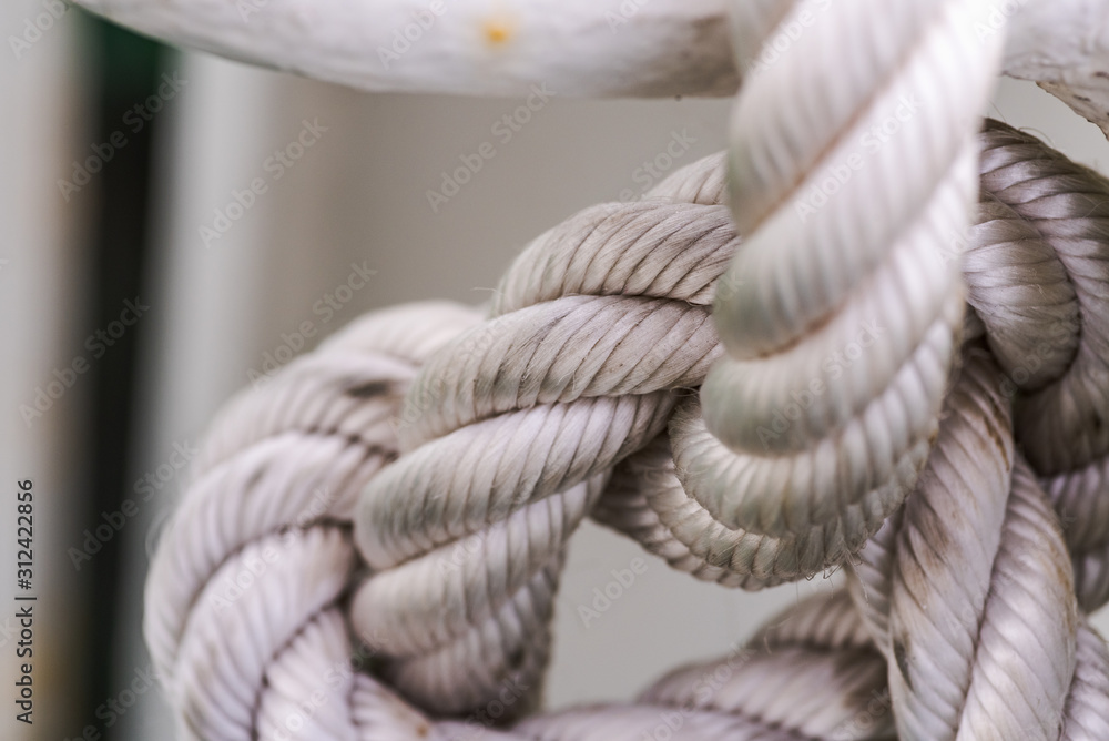sailor knot made with thick white rope with white rusty background ...