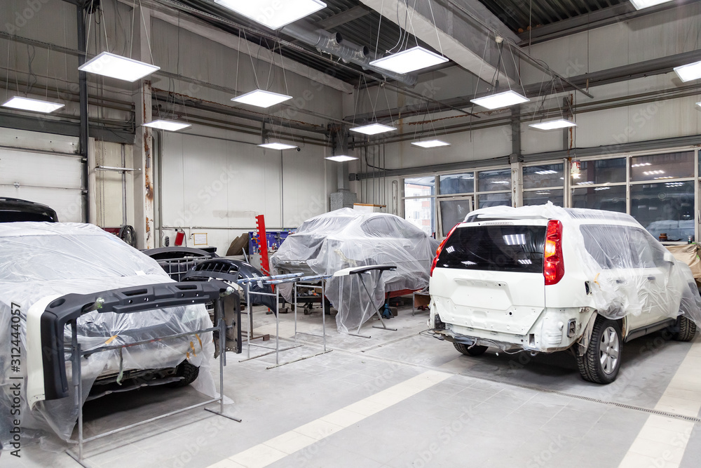 Auto bumper part is installed on the racks after painting in the car ...