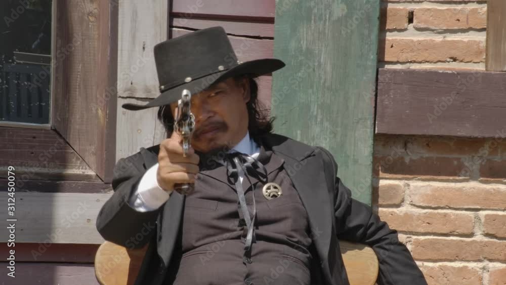 A sheriff and his deputy sitting and standing outdoor infront of ...
