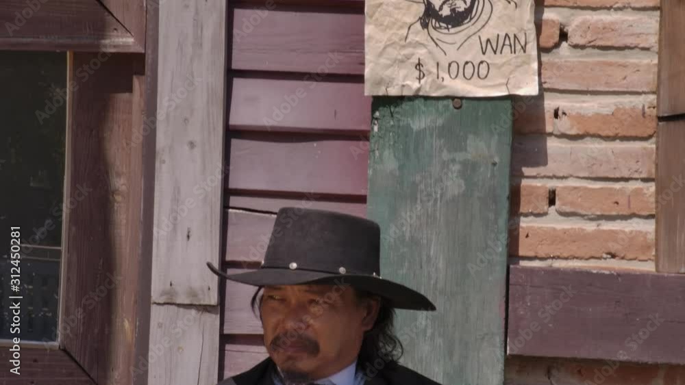 A sheriff and his deputy sitting and standing outdoor infront of ...