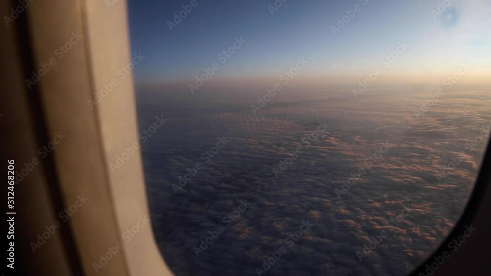 Sunset view out a plane window from 35,000 feet, over the plains states ...