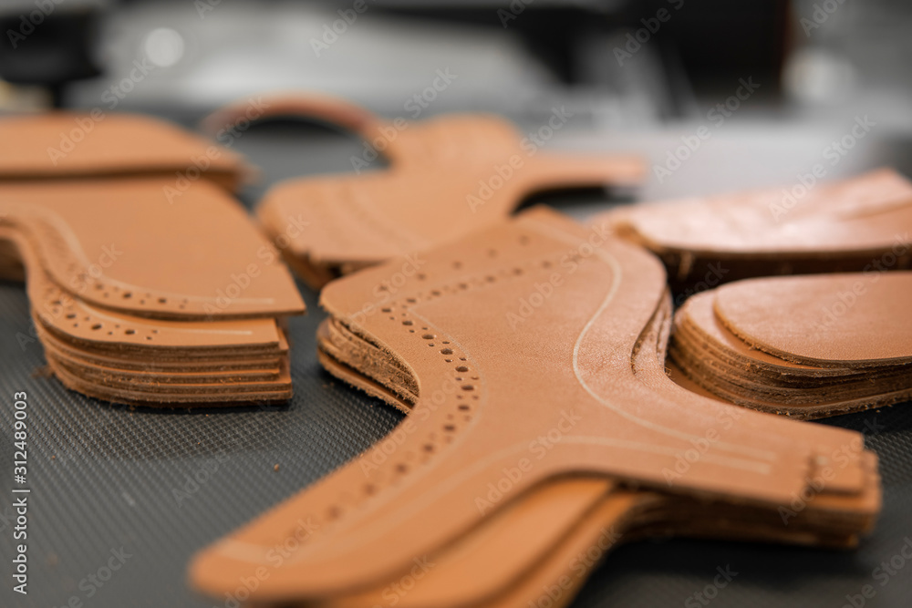 Different forms of leather pieces which will be use for making a shoes ...