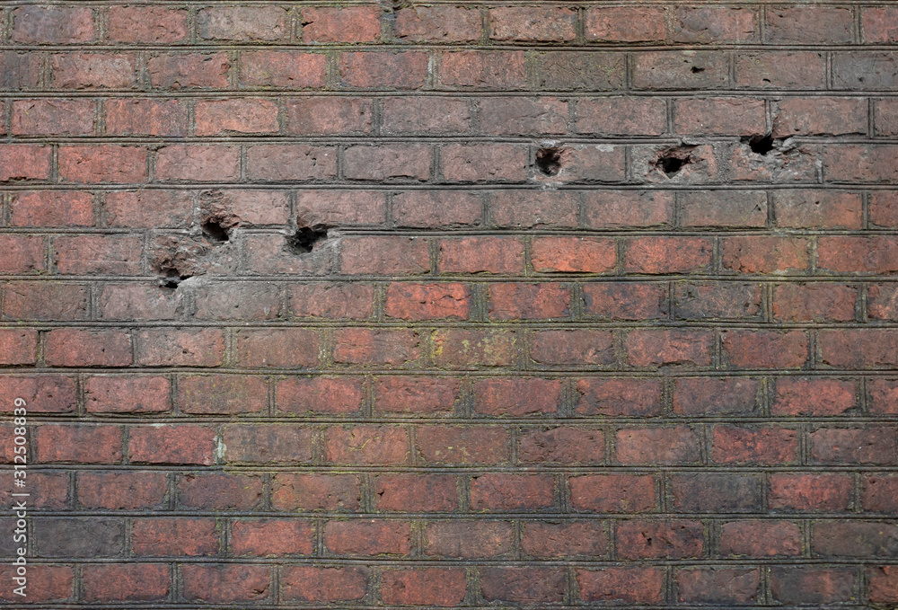 Large-caliber bullet holes in the old bastion wall Stock Photo | Adobe ...