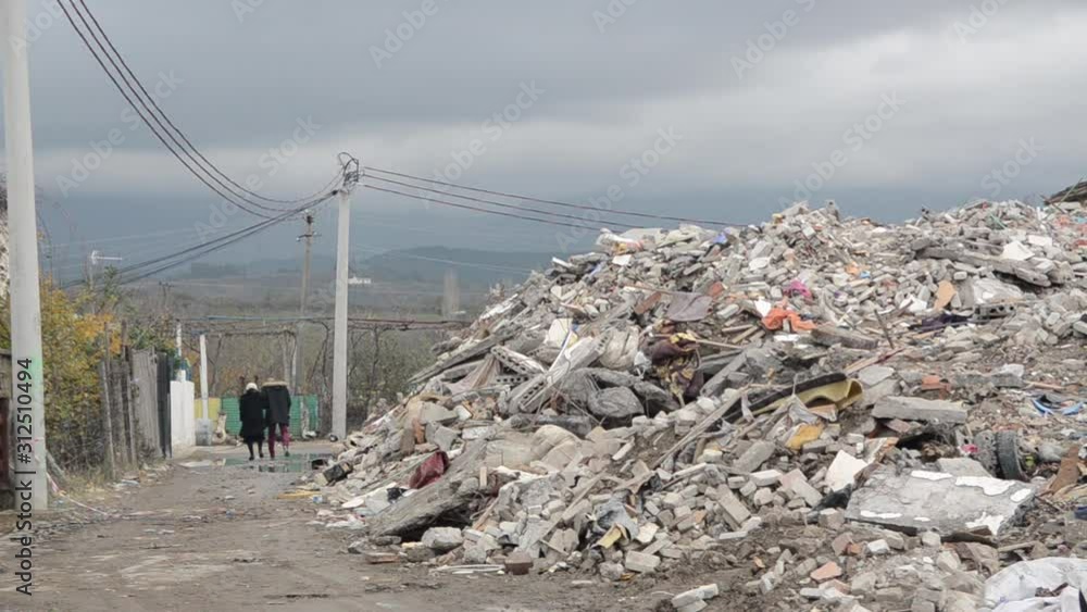 Earthquake remains. Demolished buildings in city. Pieces of rubble ...