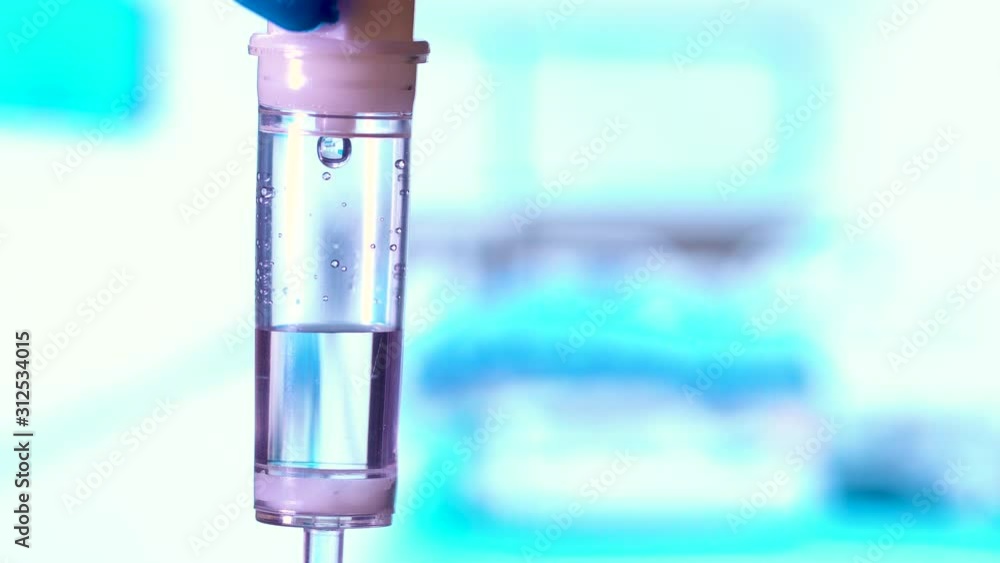 Dripping medical perfusion close up equipment in clinic background ...