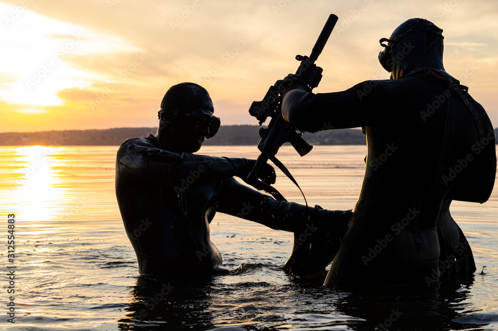 Team of fighters of a special unit move on water to complete the task ...