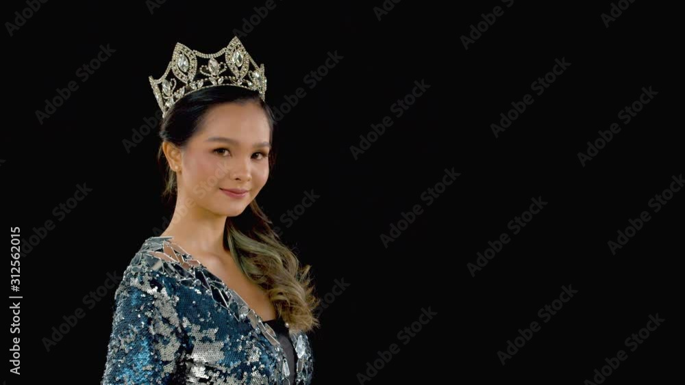 Miss beauty pageant winner smiles and waves while wearing a jeweled ...