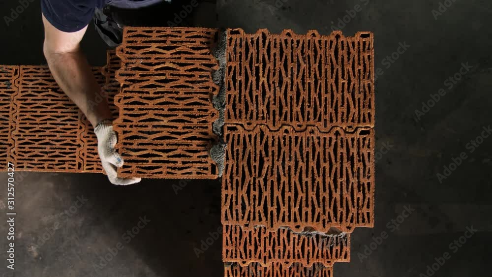 Builder laying brick blocks and putty. Stock footage. Close-up process ...