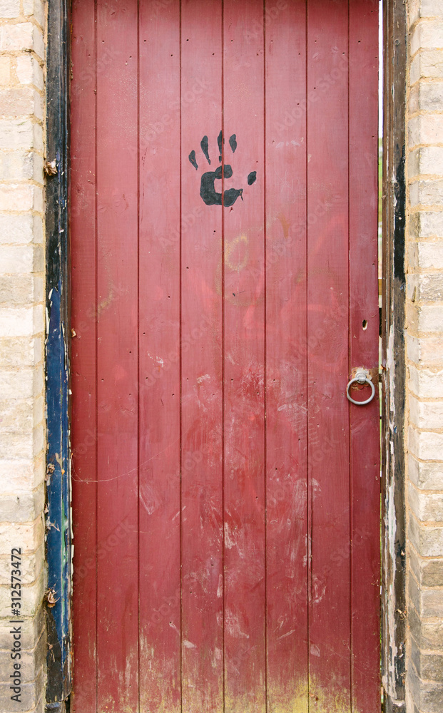 Black handprint on a door. Stock Photo | Adobe Stock