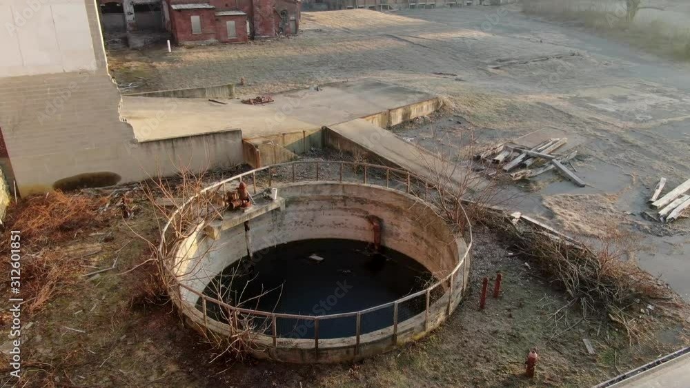 Aerial tilt down reveals large cistern full of contaminated chemicals ...