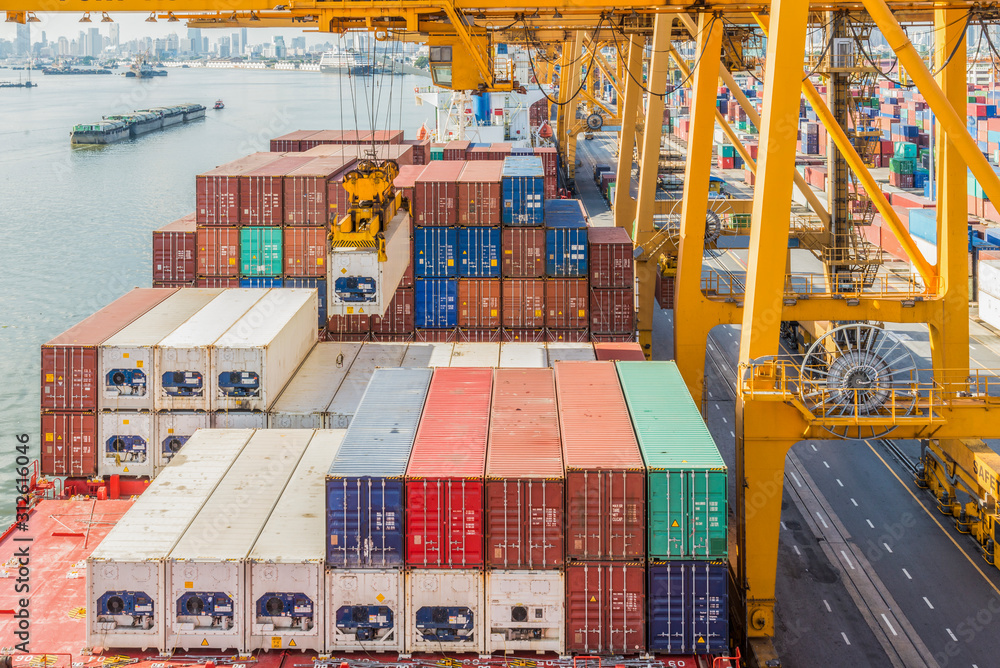 Container Cargo freight ship with working crane loading bridge in ...