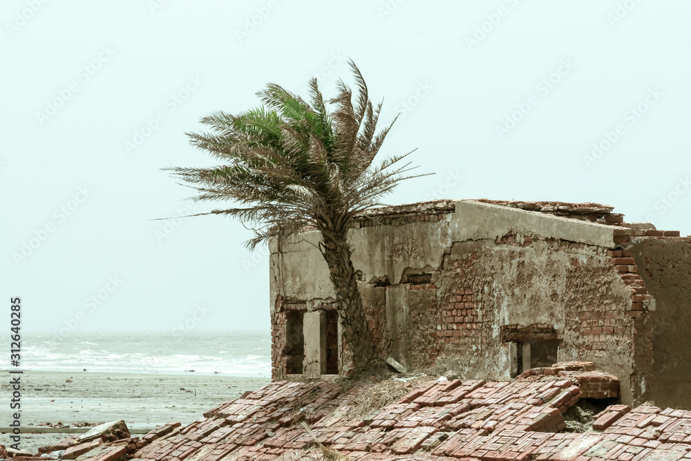 An old ruin abandoned house by sea beach. Damaged broken demolished ...