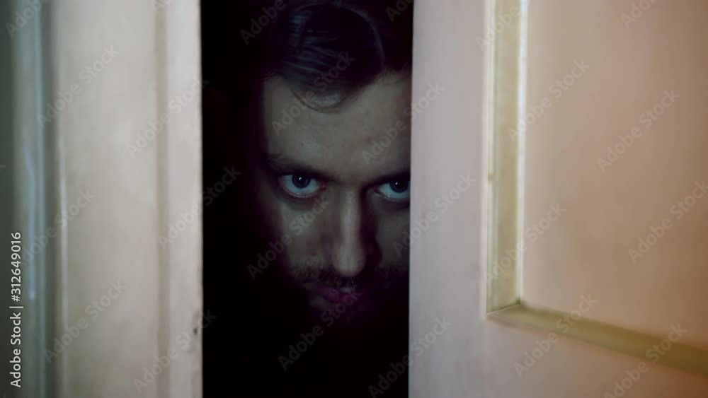 Evil Face in Dark Looking in Door Gap. Mad Serial Killer. Horror Eye ...