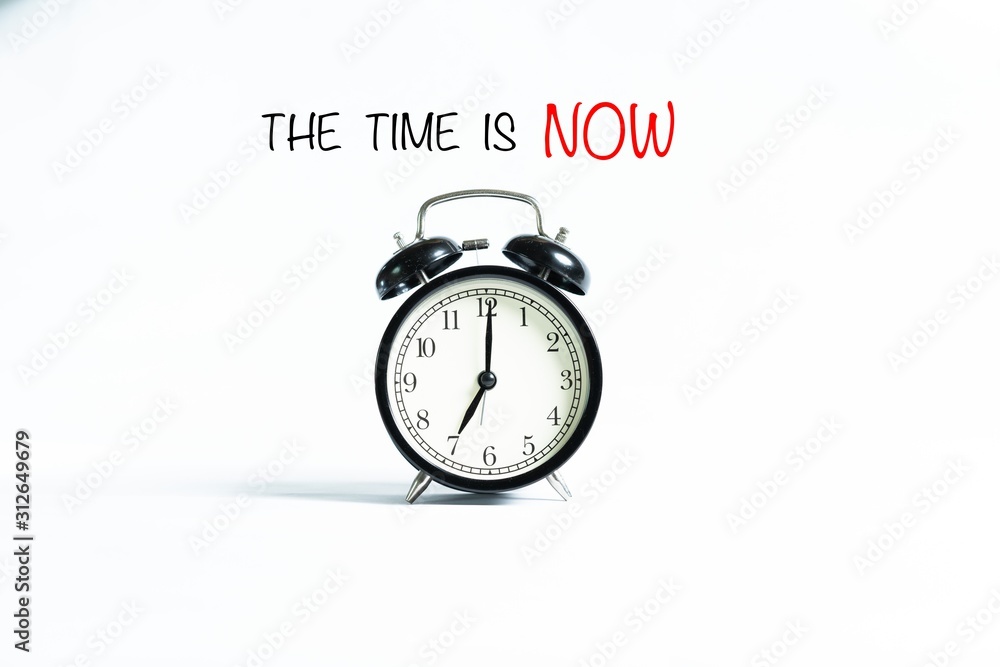 “THE TIME IS NOW” wordings with alarm clock against white background ...