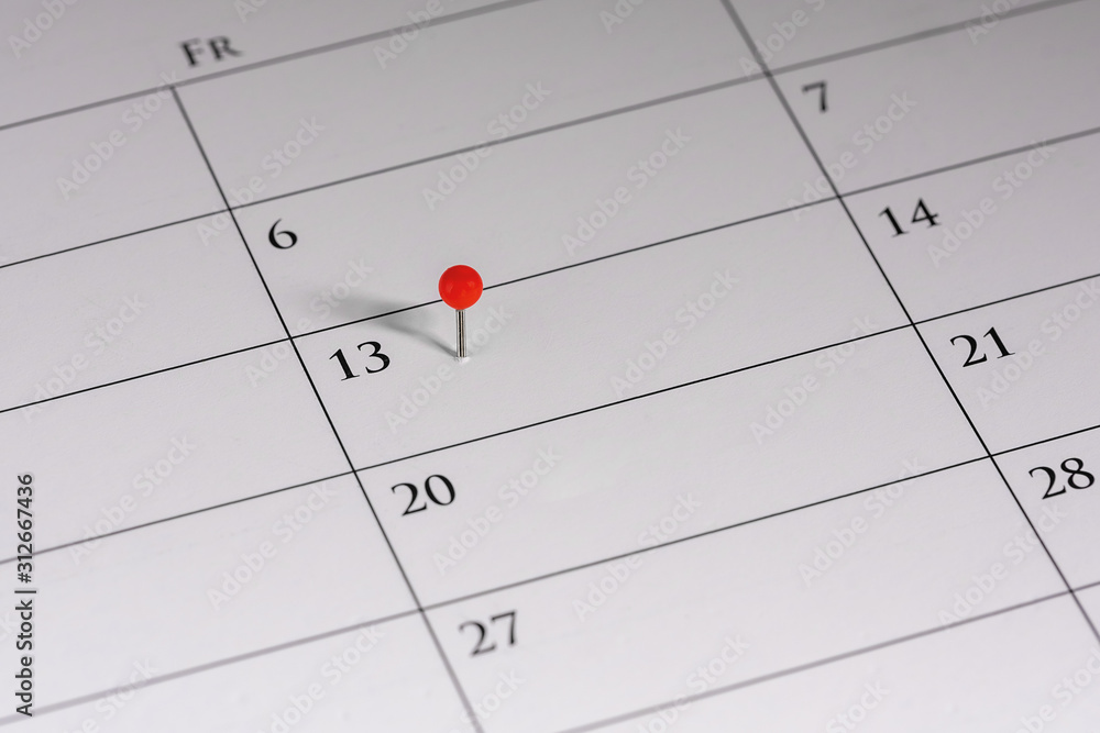 Friday the 13th is marked on the calendar with a pin with a red head ...
