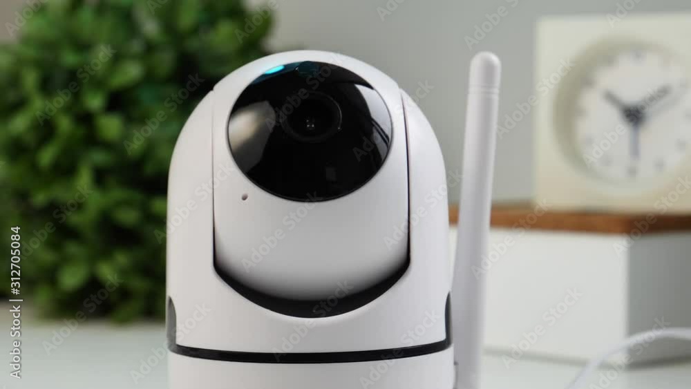 WiFi controlled home security camera moving filming around. Smart home ...