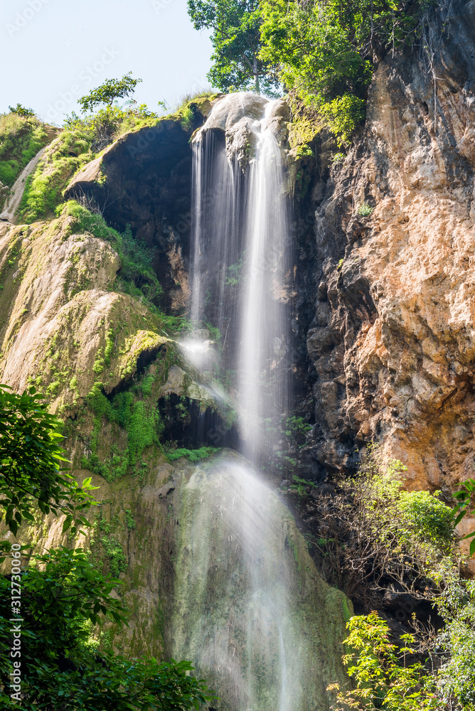 Waterfall flowing from high mountain cliff in Erawan national park ...