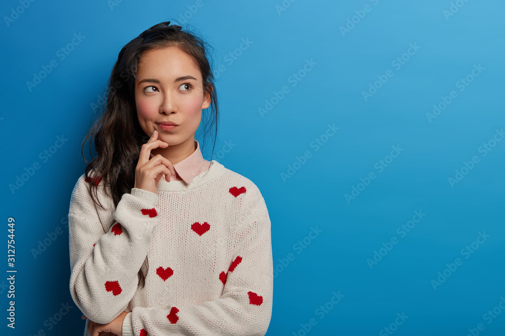 Contemplative pretty millennial young Asian woman looks away, builds ...