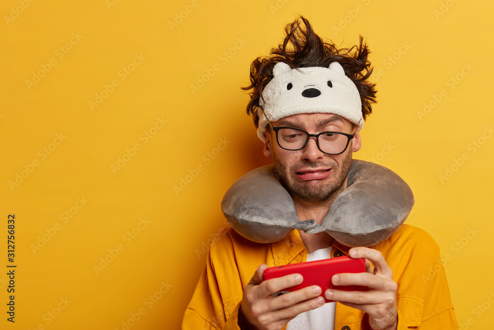 Addicted traveler plays video games on smartphone, has sad face ...