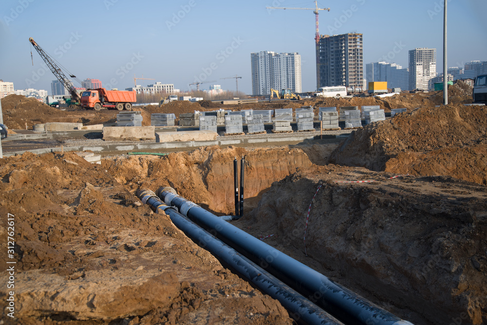 Laying of underground storm sewer pipes. Installation of water main ...
