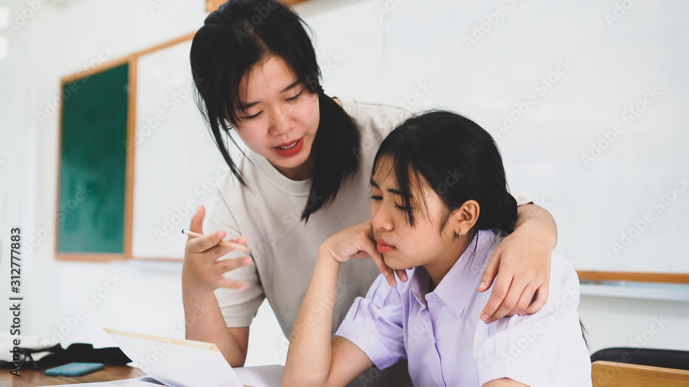 Young students holding embraces her shoulder to console girlfriend ...