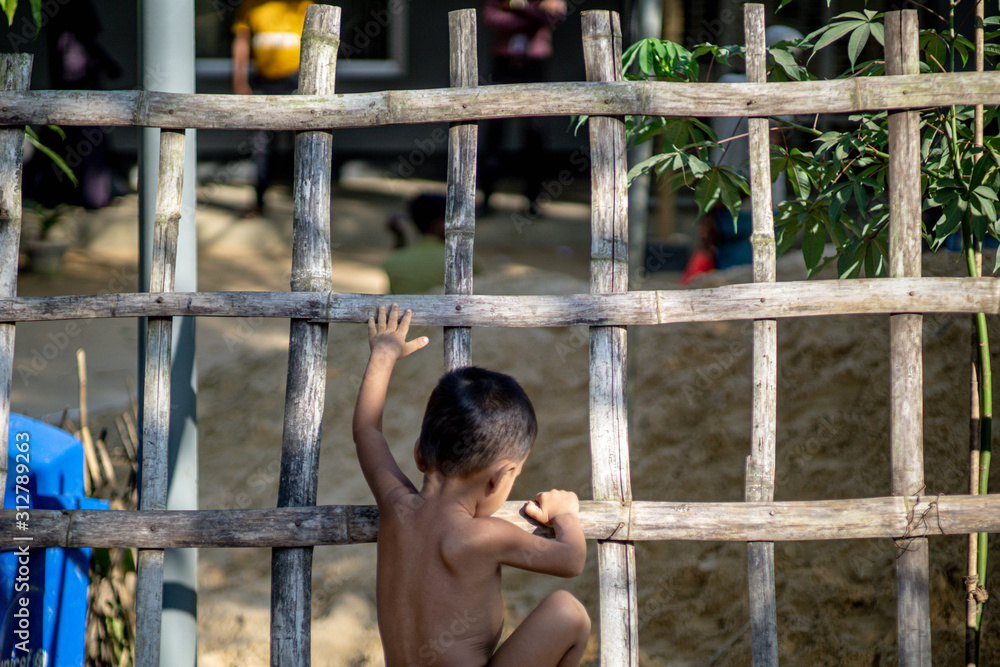 rohingya refugee children playing on the fence of refugee camp in ...