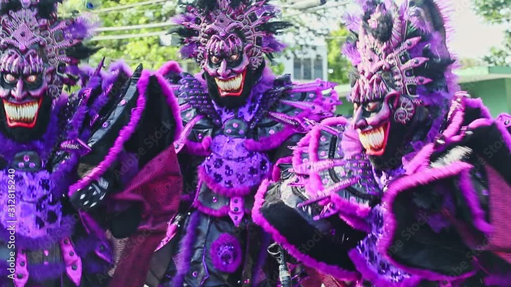 people in violet demon costumes dance at traditional dominican carnival ...
