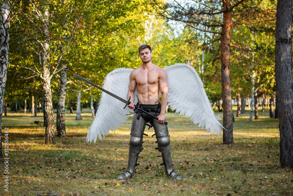 Poster A young angel, a bodybuilder in plate armor on his legs with ...