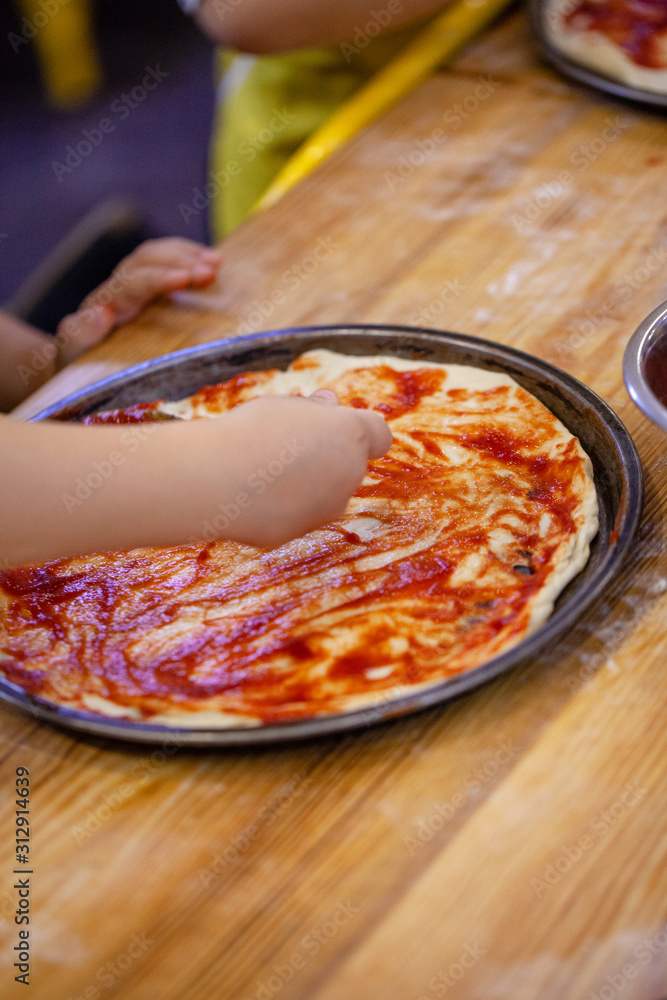 Children cooking pizza. Photo of children hands cooking Italian food ...