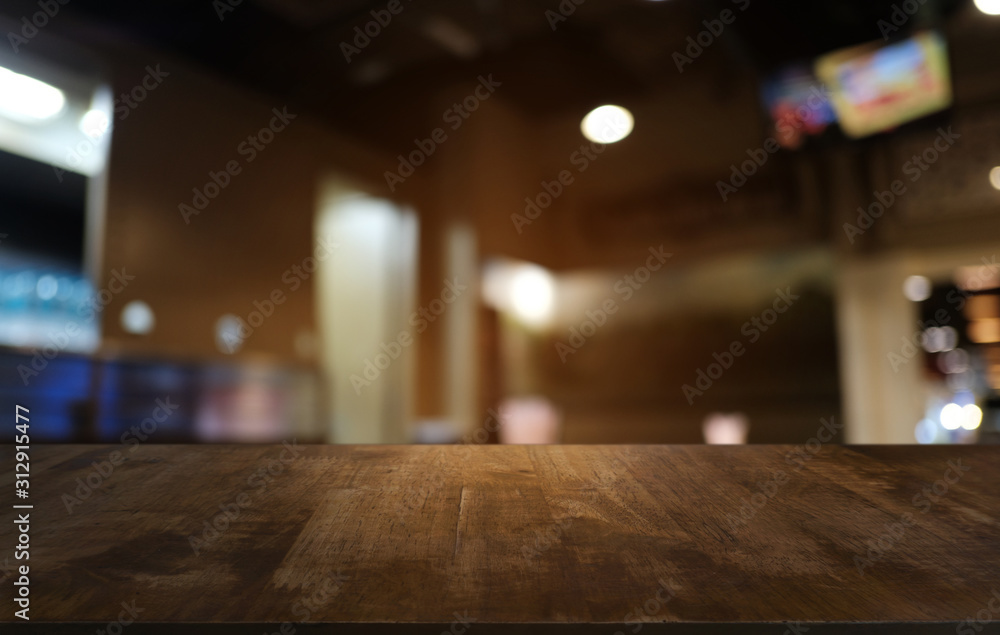 Empty dark wooden table in front of abstract blurred bokeh background ...