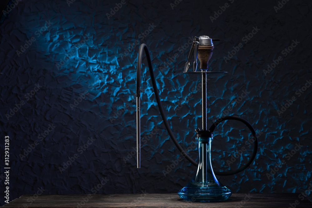 Preparing a hookah for using. Hookah on blue background. East smoking ...