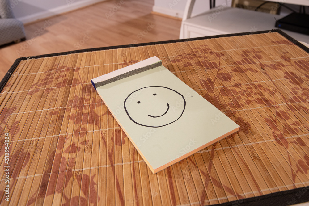 smiley face drawing on your note pad Stock Photo | Adobe Stock